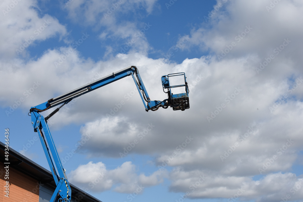 Cherry picker lift platform with telescopic arm on a building site to ...