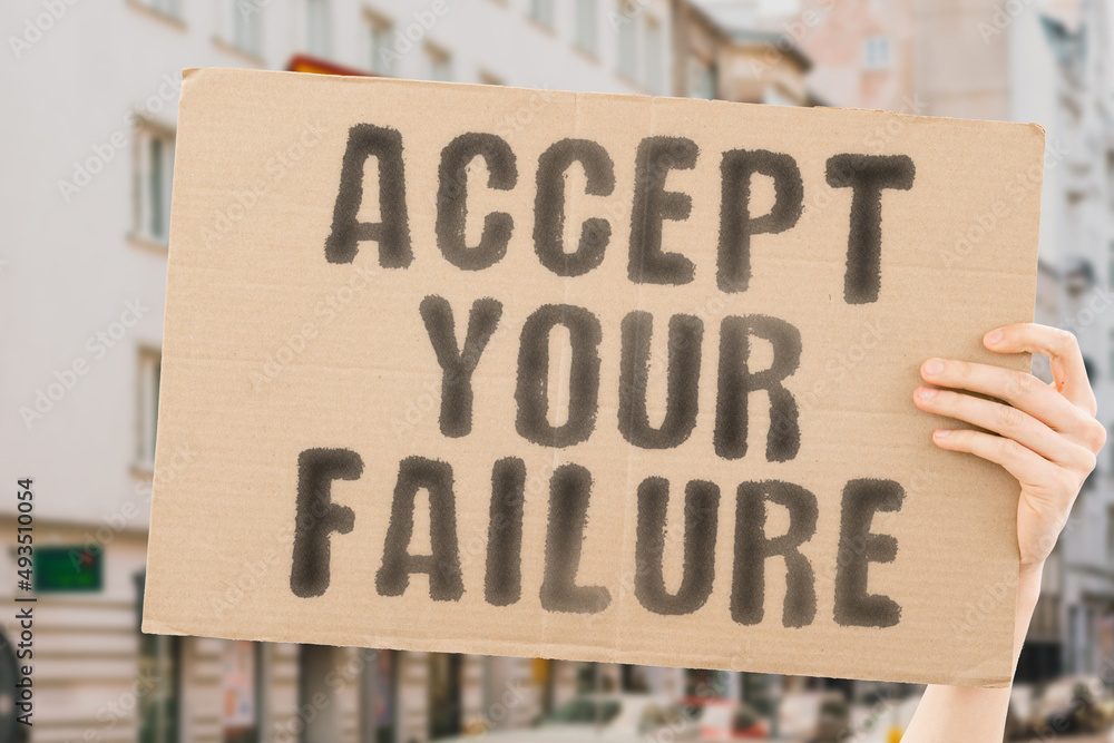 The phrase " Accept your failure " on a banner in men's hands with ...