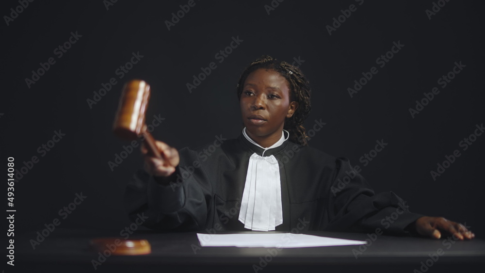 Confident African American female judge tapping gavel, announcing court ...