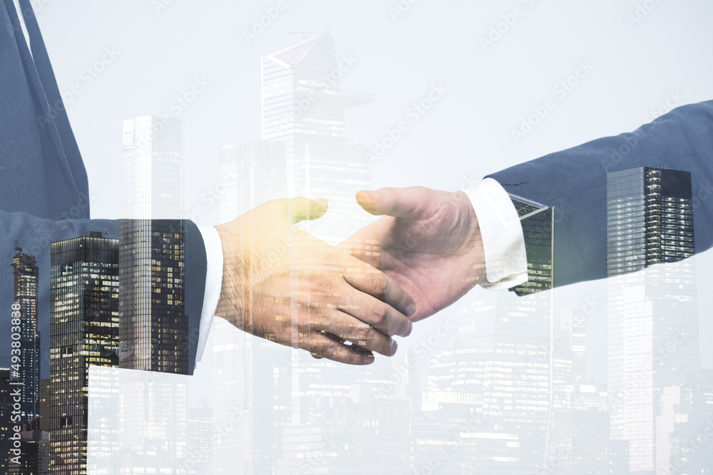 Multi exposure of handshake two businessmen on office buildings ...