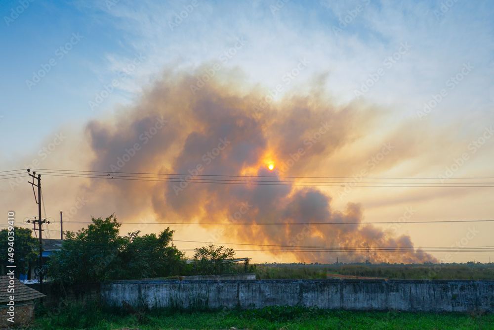 Industrial pollution is spreading like clouds and covering the setting ...