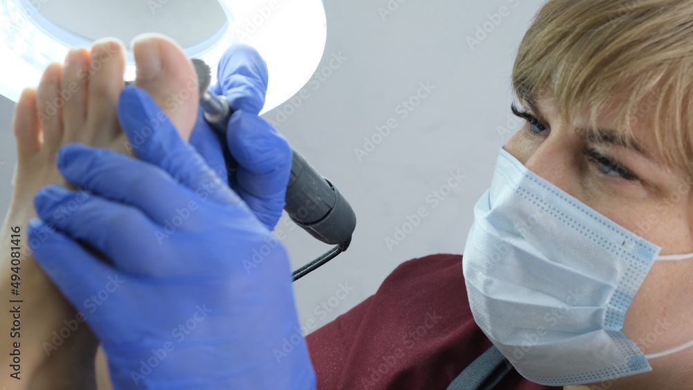 Patient on medical pedicure procedure, visiting podiatrist.Professional ...