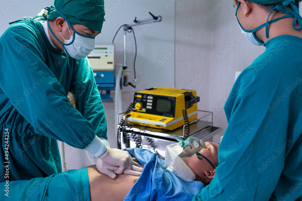 Stock-Foto „Selective at hand of Doctor and nurse using defibrillator to pump at chest of ...