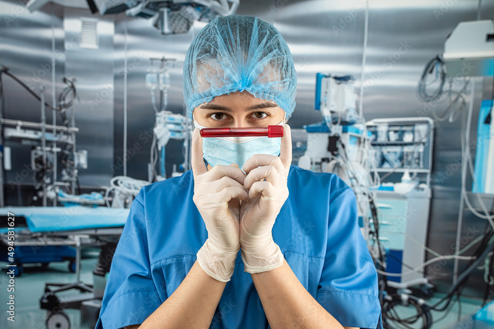 attractive doctor wearing uniform doing analysis blood probes patients ...
