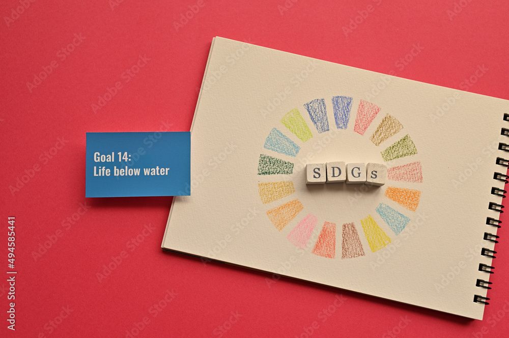 Foto de Stock Wooden cubes arranged in the letters of the SDGs and a ...