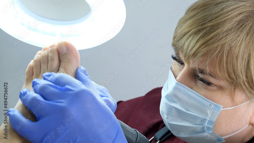 Patient on medical pedicure procedure, visiting podiatrist.Professional ...