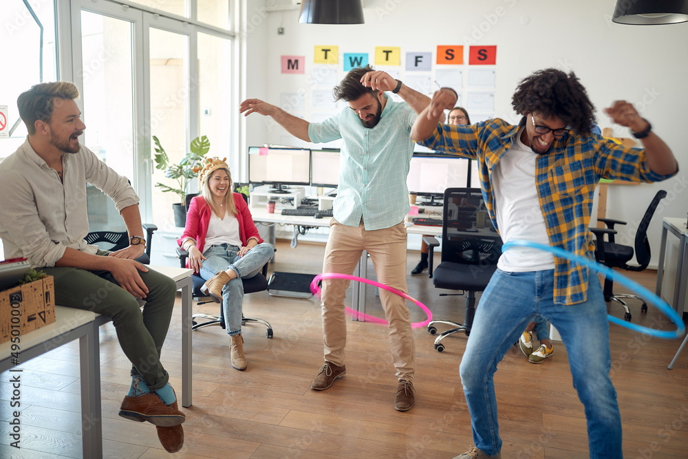 A group of employees is having fun while playing with hula-hoop in the ...