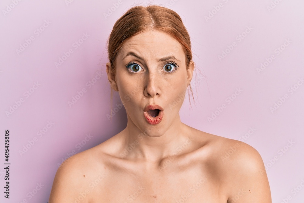 Young Irish Woman Standing Topless Showing Skin Scared And Amazed With Open Mouth For Surprise