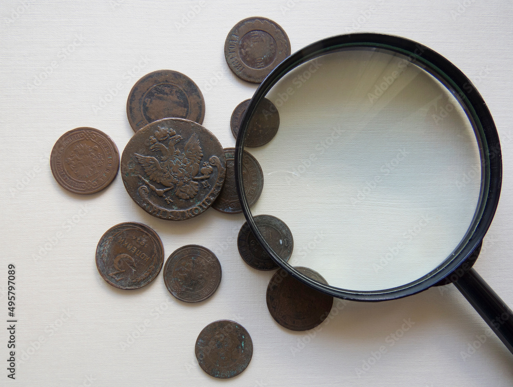 Pile of vintage metall (copper) coins. Magnifying glass and coins of ...