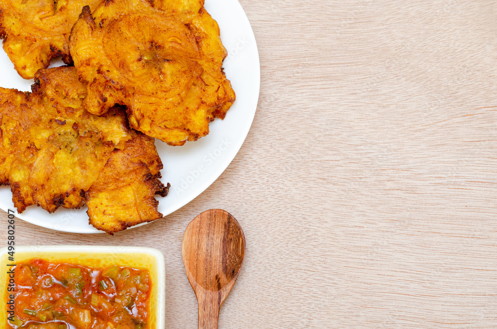 Patacones or fried tostones of green or ripe plantain, crispy, with ...