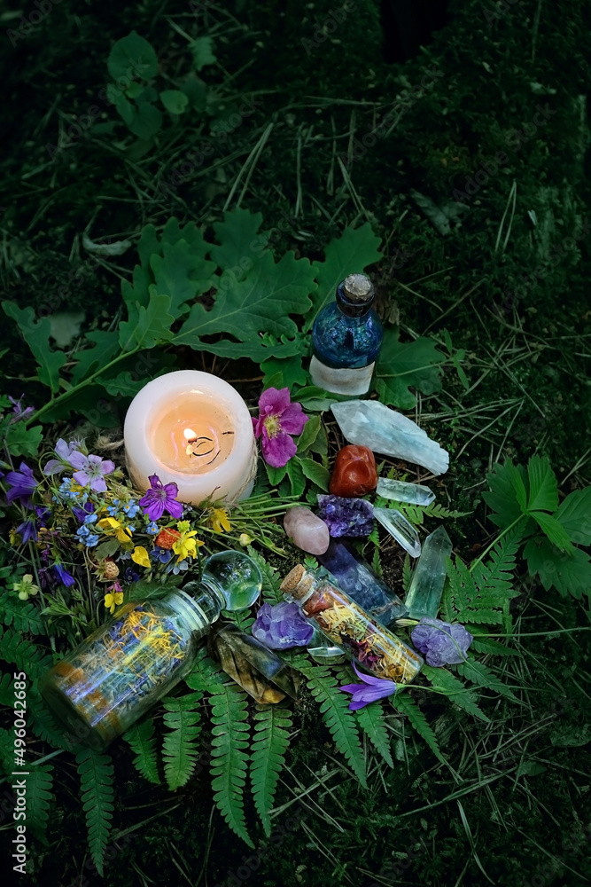 Candle, minerals, magic bottles and pentagram amulet on mysterious ...