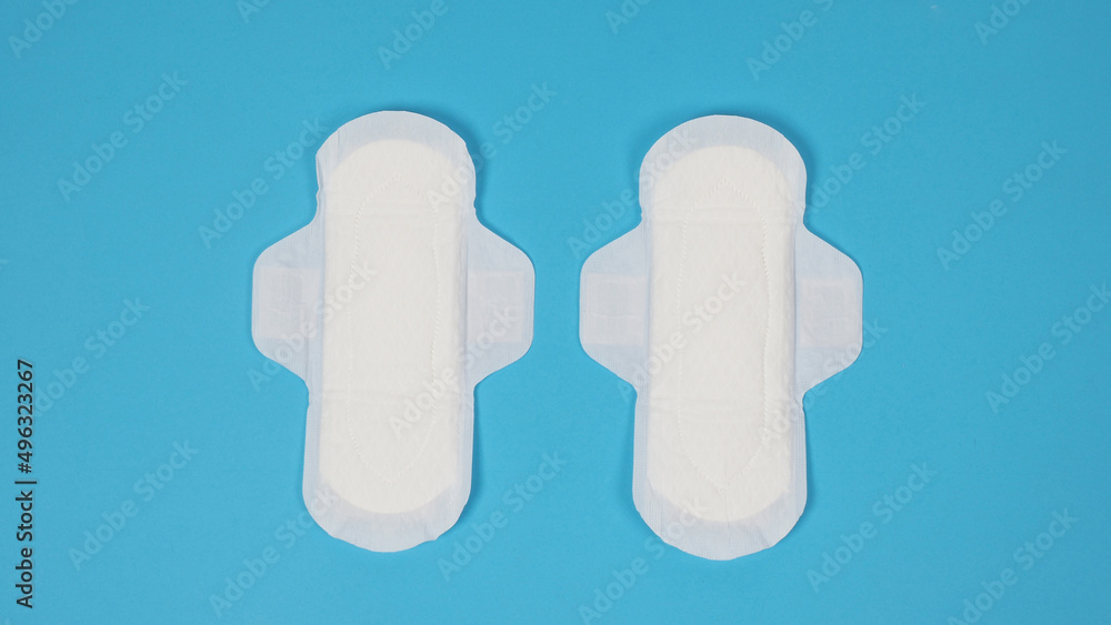 Woman sanitary napkins on blue background. Top view. Absorbent pads ...