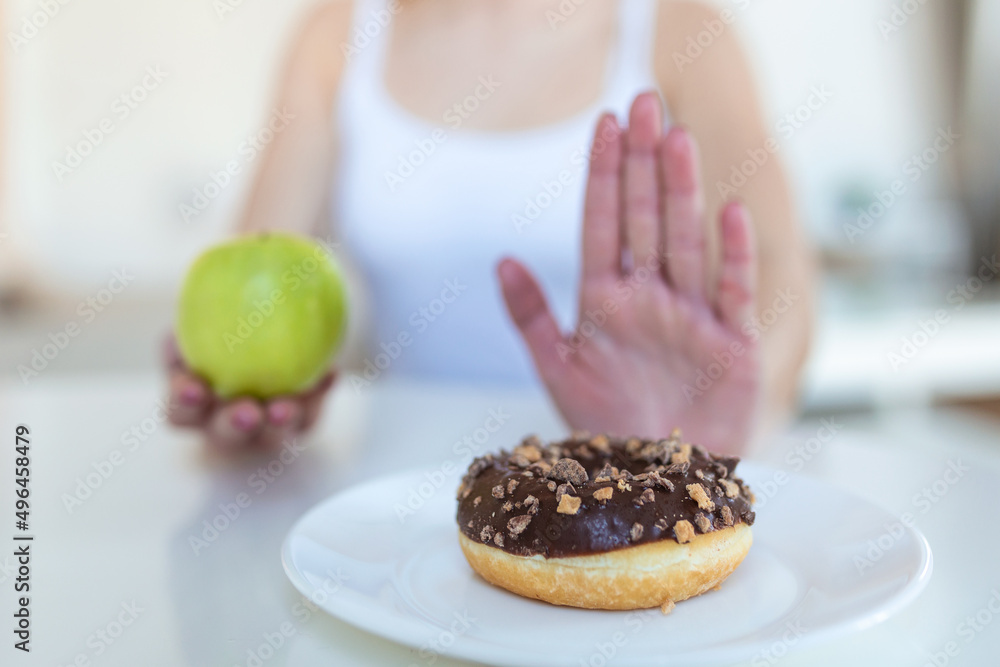 Dieting or good health concept. Young woman rejecting Junk food or ...