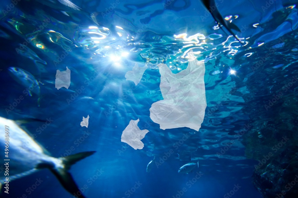 garbage bag in ocean full of plastic trash to illustrate marine ...