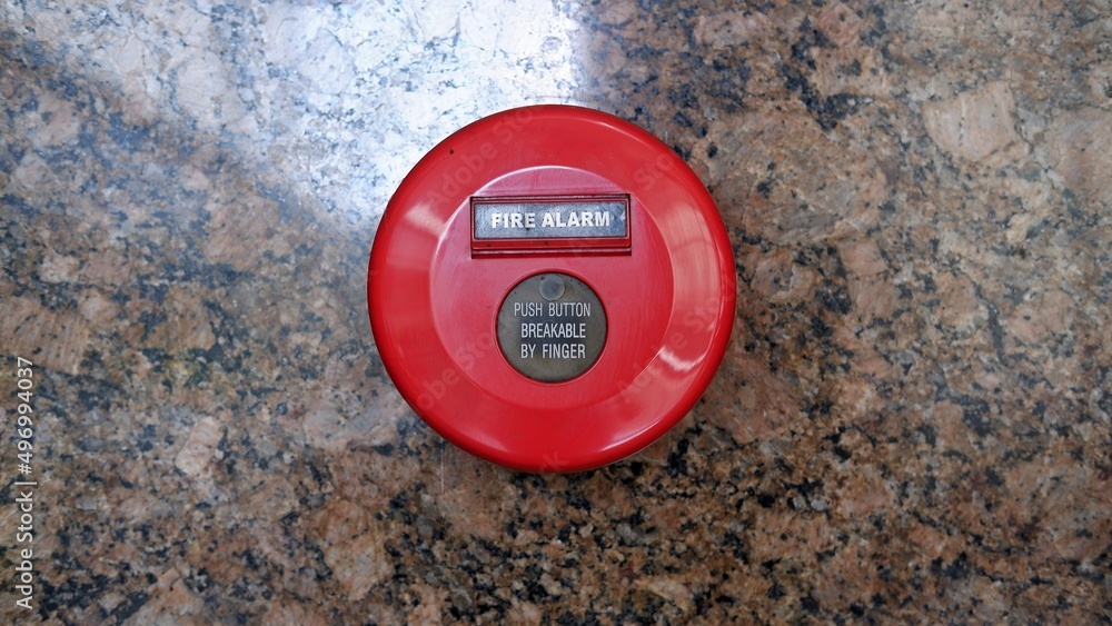 Red colour of manual fire alarm button activation in marble wall ...