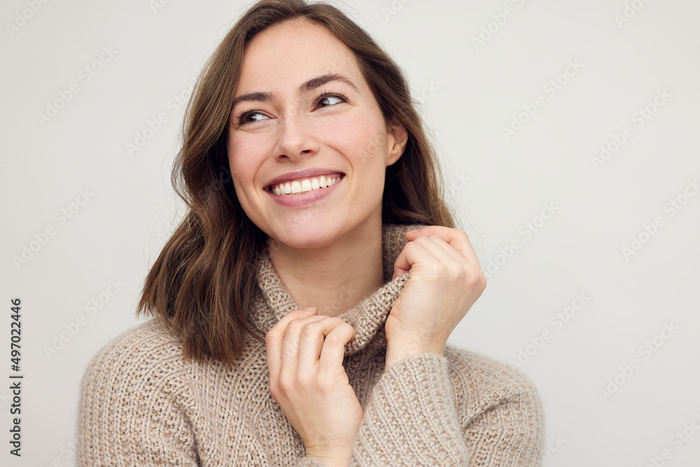 Portrait of young happy woman smiling on white background while looking ...