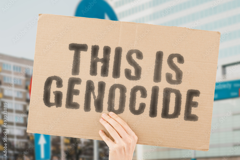 Photo Stock The phrase " This is genocide " is on a banner in men's ...