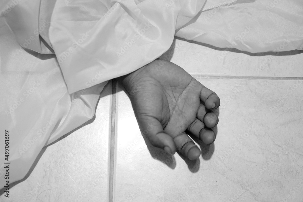 dead body laying on a floor.Focus at the Hand Stock Photo | Adobe Stock
