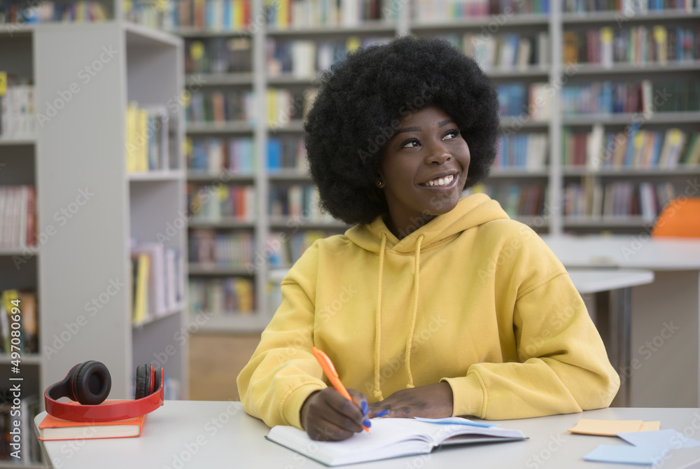 Beautiful smiling African American student studying, taking notes, exam ...