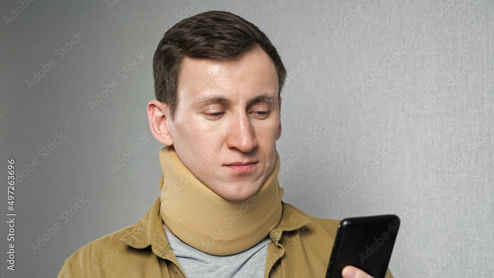 Young man wears bandage on neck to stabilise spinal column. Male person ...
