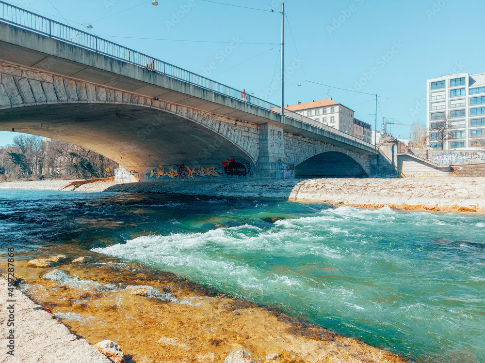 Old stone bridge. Beautiful landmark in the city of Munich, in Germany ...
