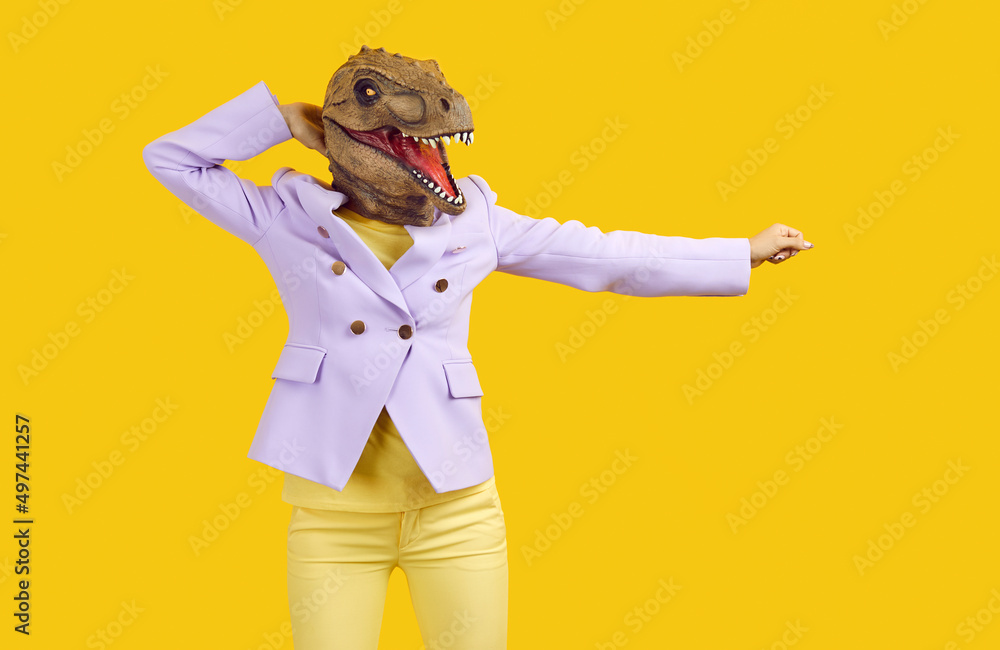 Woman in extravagant disguise having fun in studio. Happy confident ...