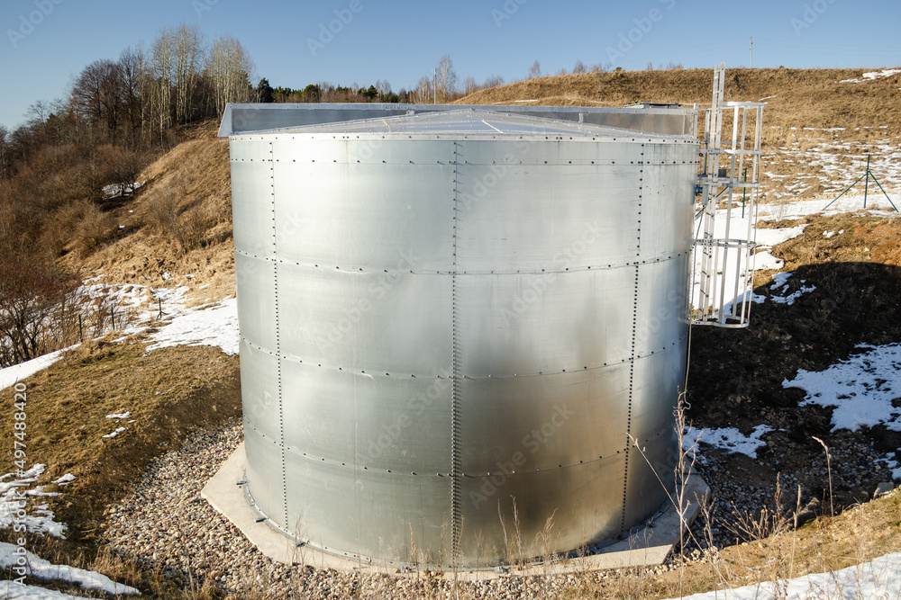 Large new metal tank with stairs and rivets. Stock Photo | Adobe Stock