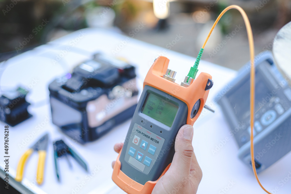 Internet technicians are measuring light signals using power meter ...