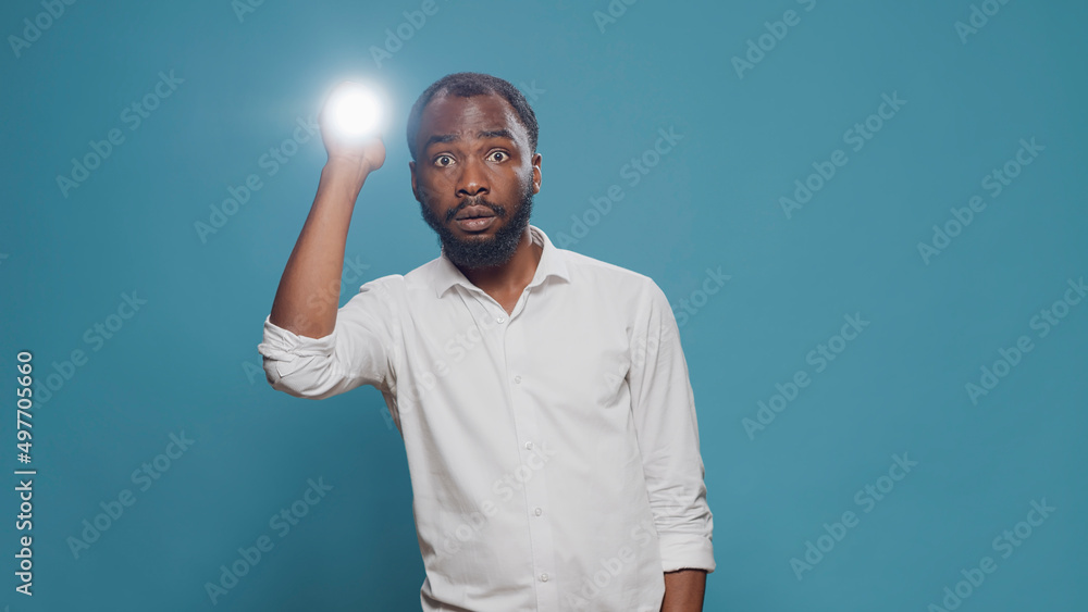 Confused person using flashlight to look for mysterous sound source ...