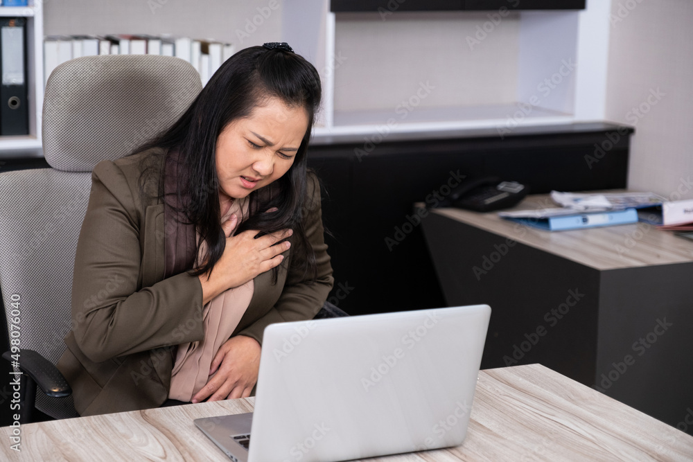 Adult business women feeling painful from chest ache while working ...