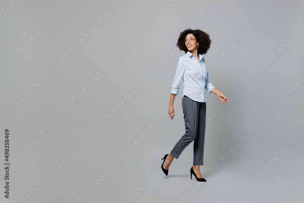 Full body side view smiling fun young employee business corporate lawyer woman of African ...