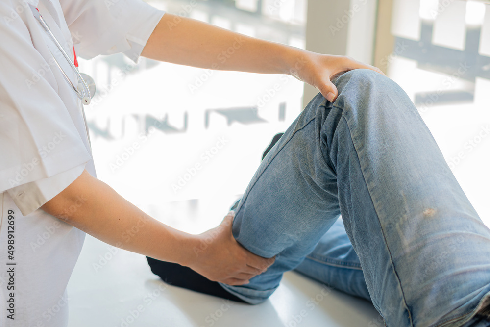 Physiotherapy concept image of a young man with injured leg giving ...