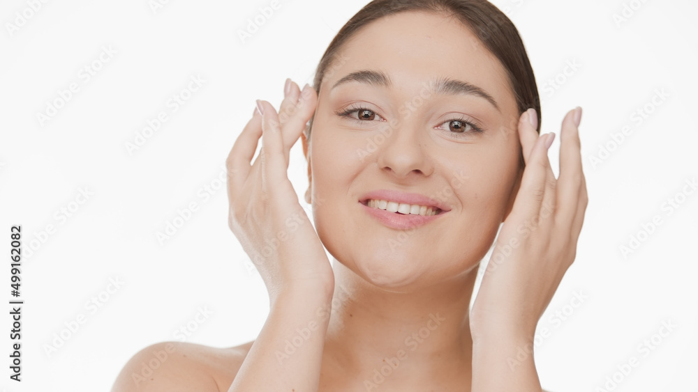Positive Caucasian young plus size woman massages her temples ...