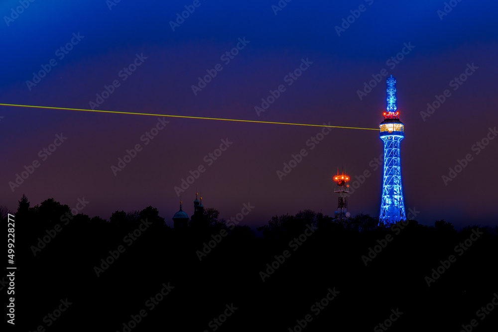 Foto de Stock The Petřín tower illuminated in blue in Prague. Laser ...
