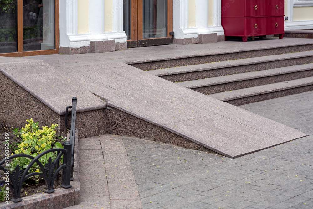 Photo Stock Ramped access, using wheelchair ramp for disabled people ...