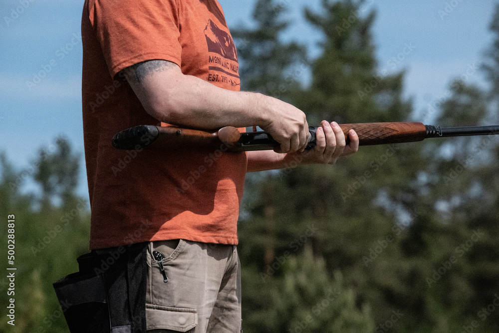 Hunting rifle firing. Hunting in the forest. Hunter loading gun with ...