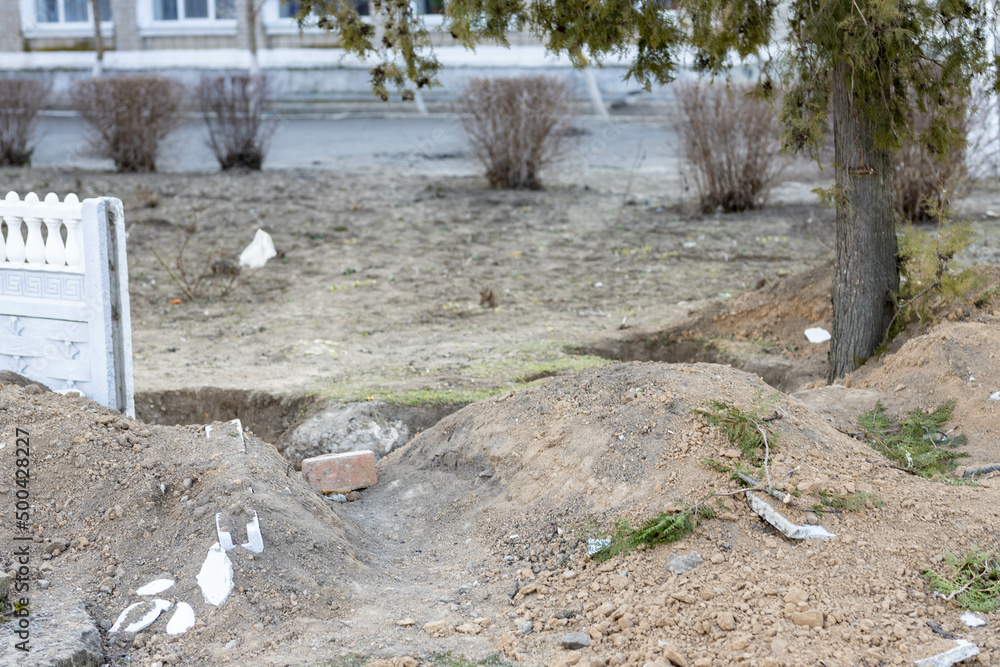 The trenches were dug near school in village under ruined fence and ...