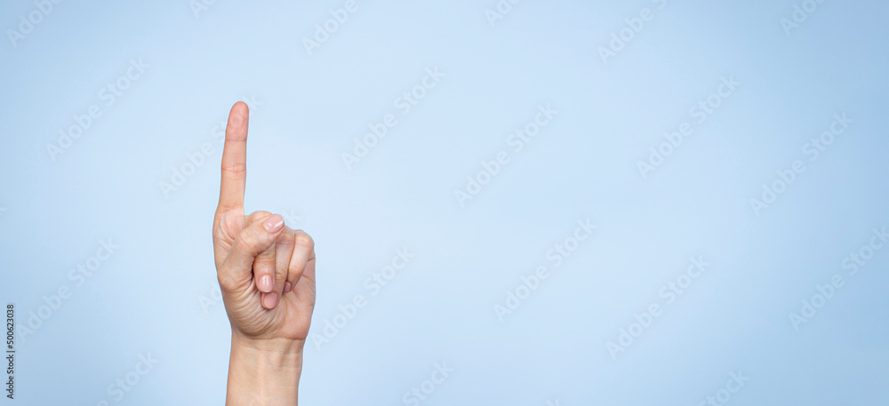 Hand gesture. Female hand shows number one. Woman pointing up with ...