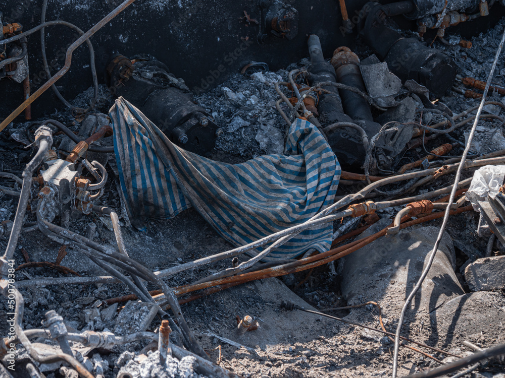 Remains of a Russian soldier's clothes in burnt military equipment. A ...