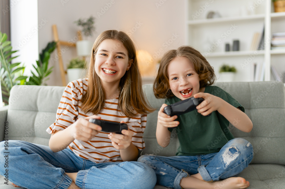 Children playing video games Stock Photo | Adobe Stock