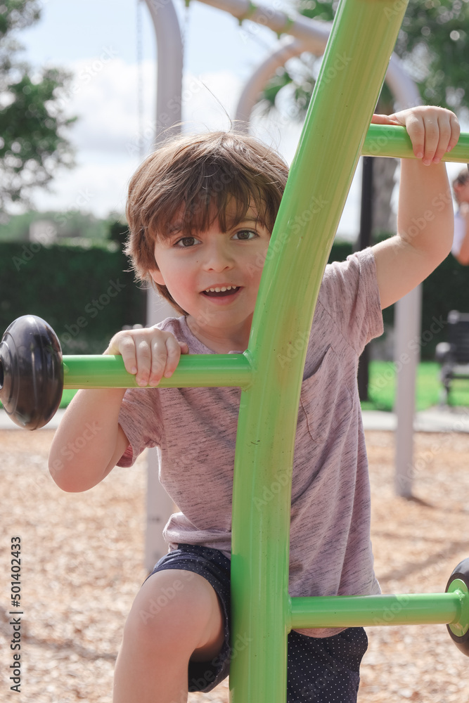 boy playing on a playground climbing up the ladder Stock Photo | Adobe ...