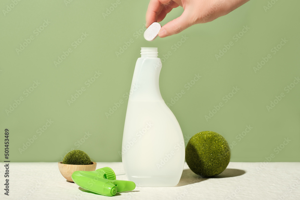 female hand holding refill tablet for cleansing detergent. home ...