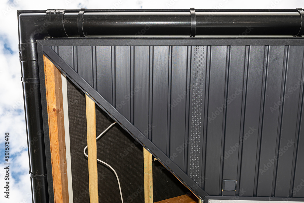 Scaffolding with three rows of wooden battens and a modern graphite ...