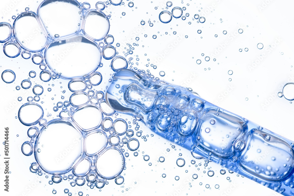 Cosmetic liquid dropper macro with clear blue skincare serum in pipette ...