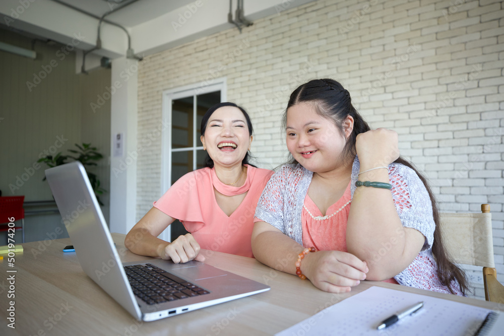 down syndrome teenage girl and her teacher studying how to use laptop ...