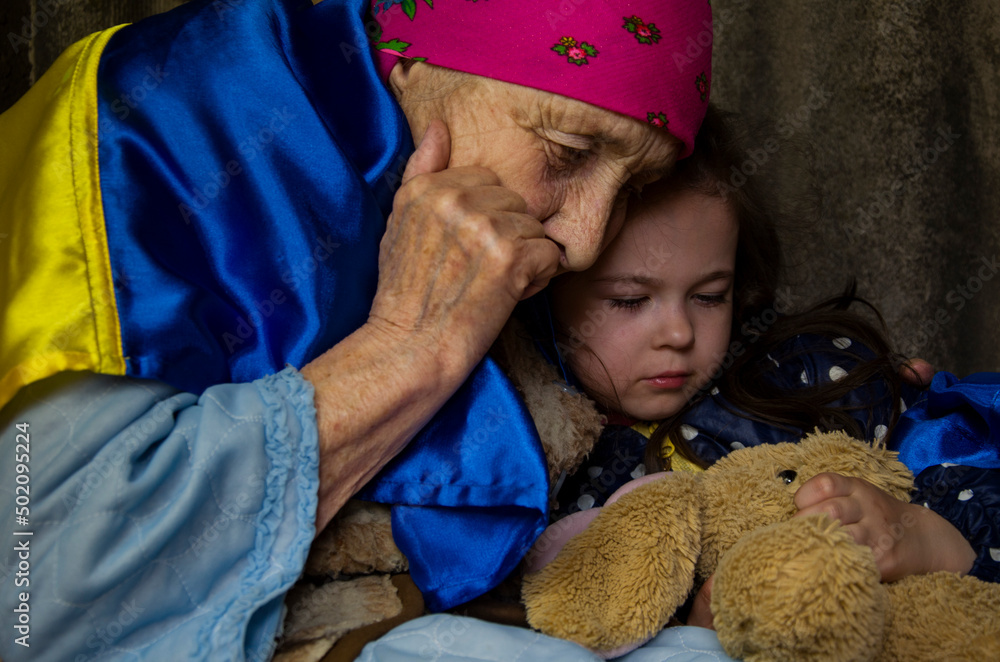 Photo Stock A child and grandmother hide in the basement during an air ...