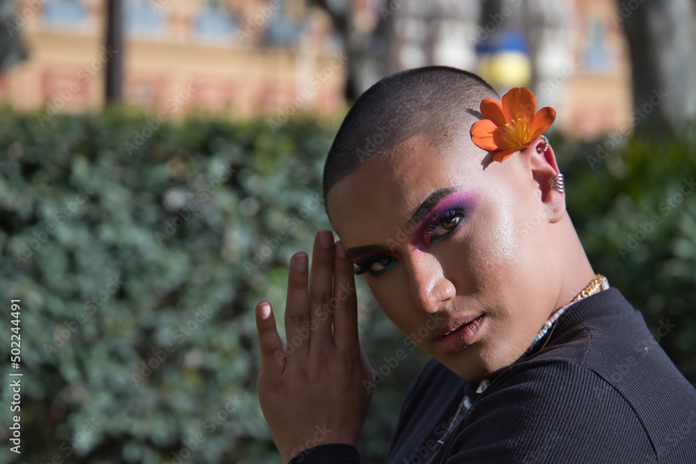 Portrait of non-binary person, young and South American, heavily make ...