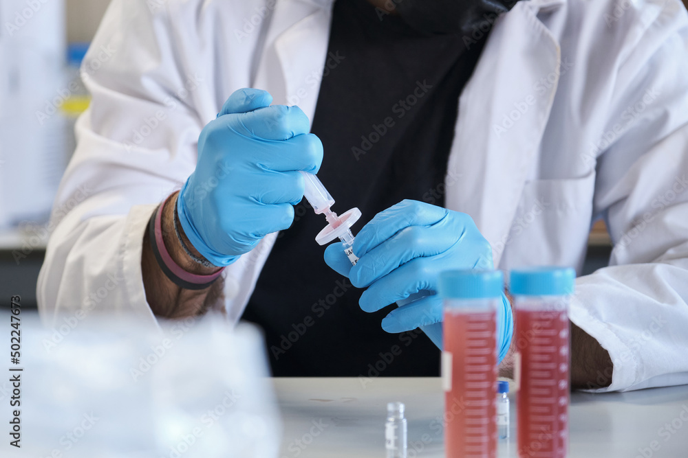 Scientist in white lab coat filter sample into HPLC vial. High ...