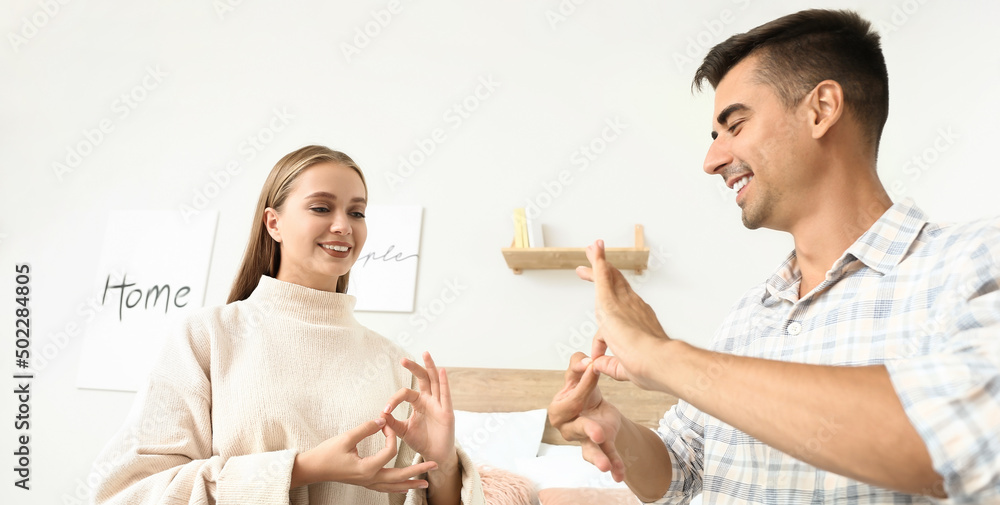 Young deaf mute couple using sign language at home Stock Photo | Adobe ...
