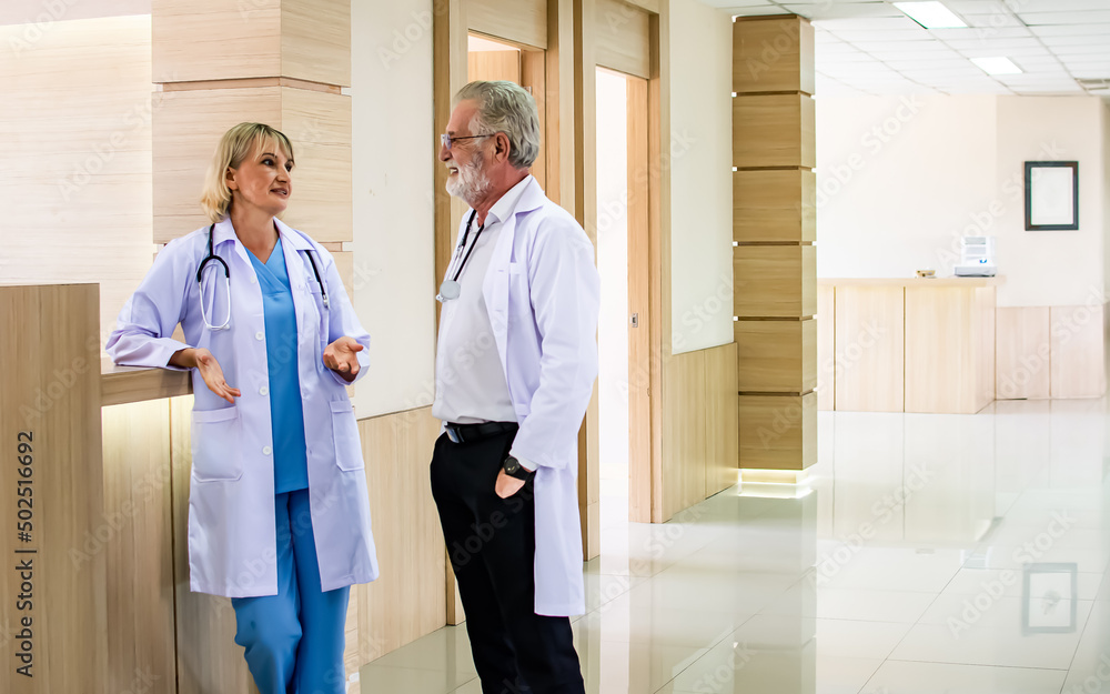 Caucasian senior beard male and female doctors wearing white gown ...